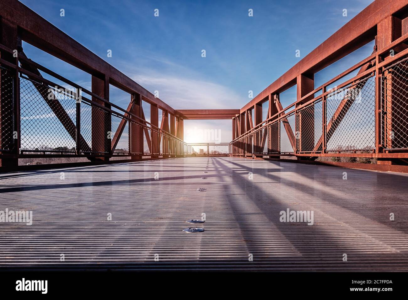Beautiful scenery of sun rays shining through a bridge in Winston Salem ...
