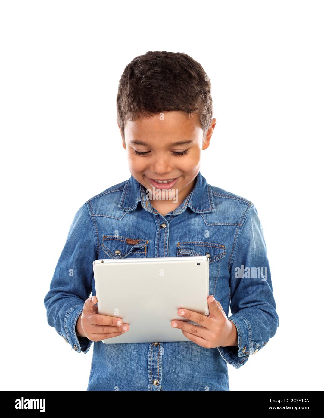 Latin child looking at a tablet isolated on a white background Stock ...