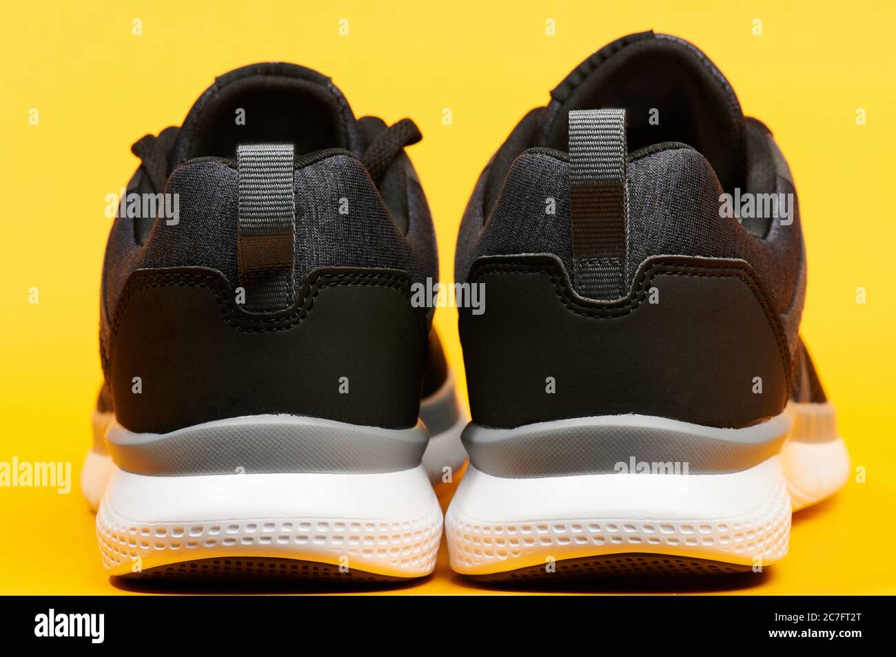 Back view of black sport shoes close up view on yellow background Stock ...