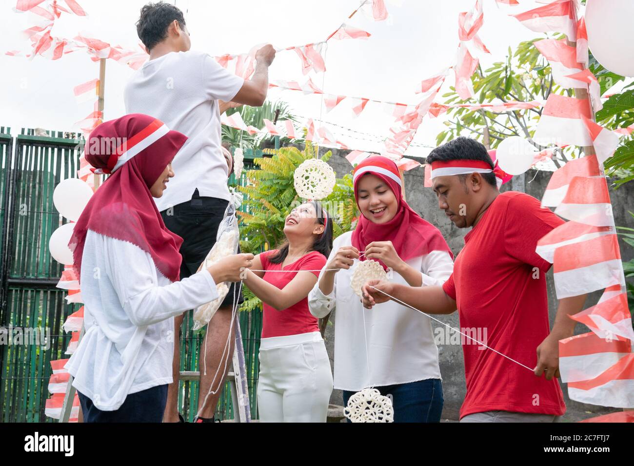 group of young people put up ropes and crackers preparing together for ...