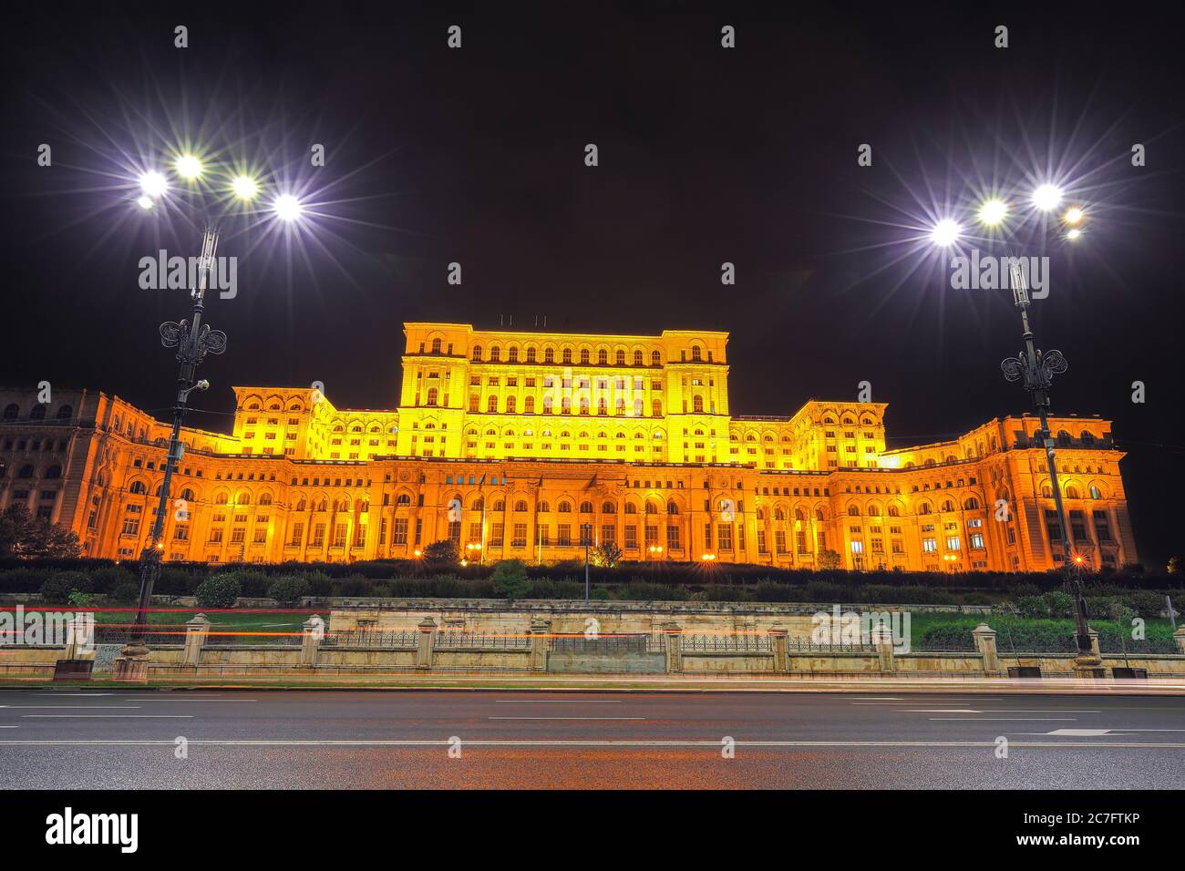 Illuminated Palace of the Parliament of Bucharest at night. Dramatic ...
