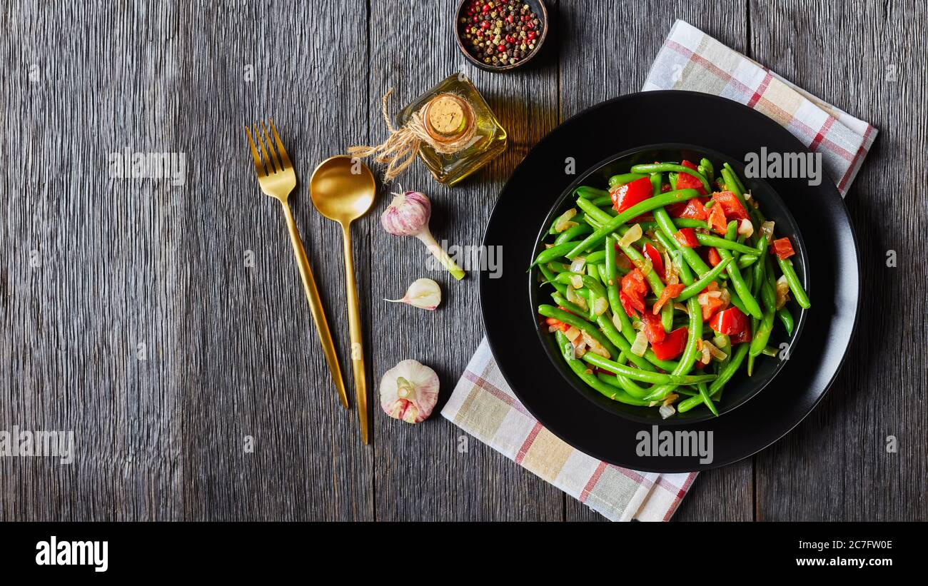 close-up of stir-fry yard beans with onions and tomatoes, Fry bodi in a ...