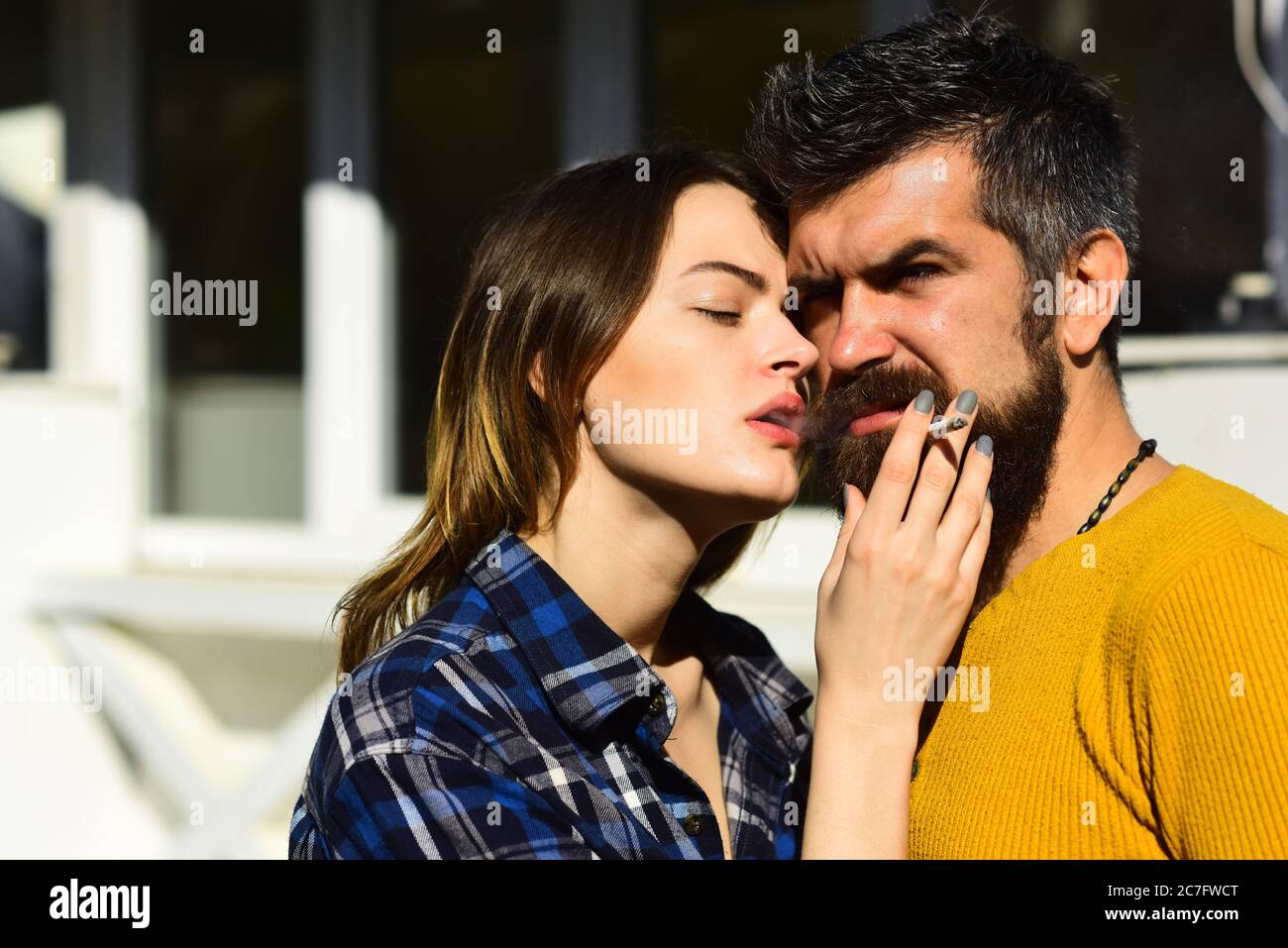 Sensual couple puffing smoke into face. Woman with eyes closed and ...