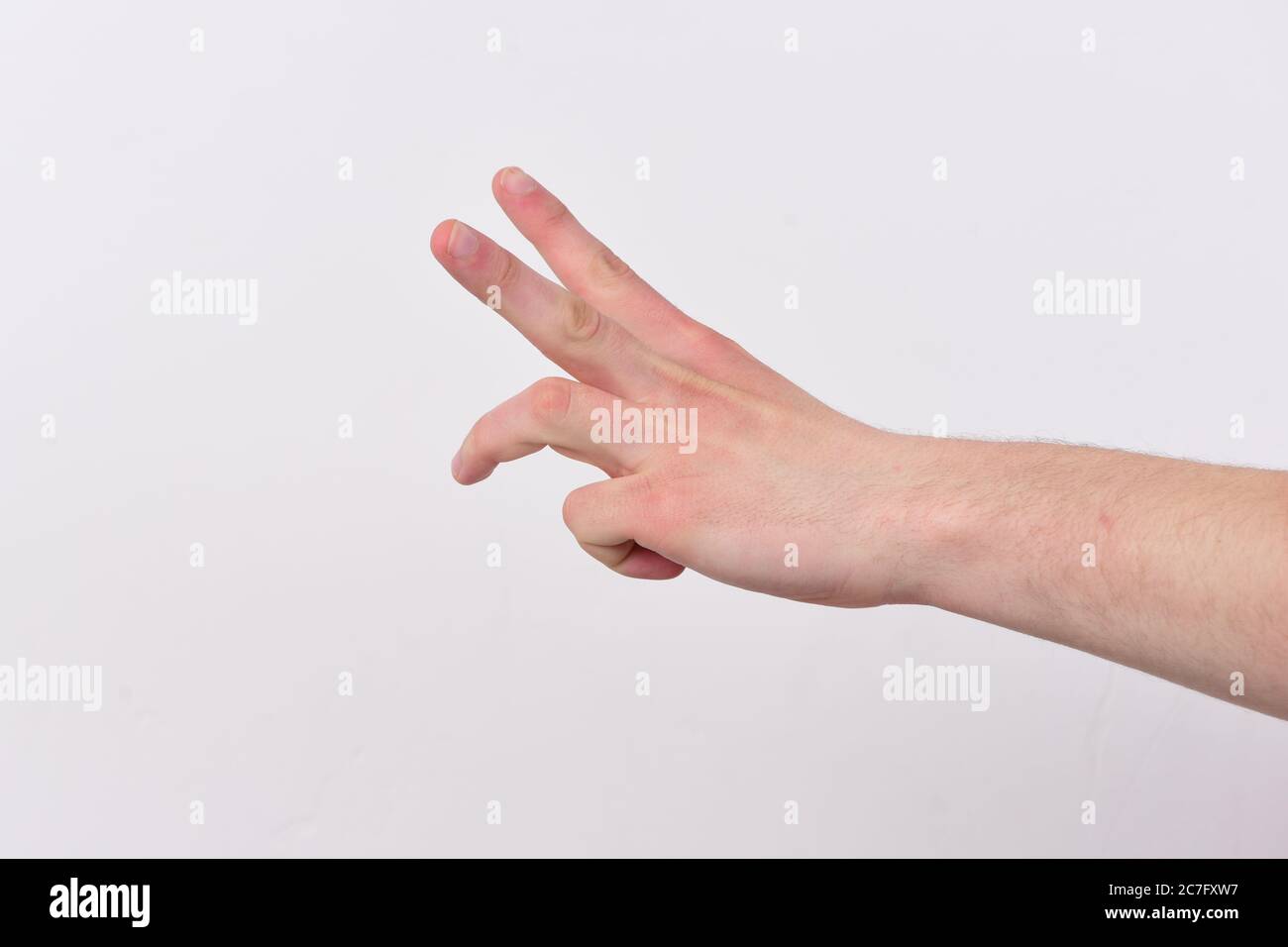 Male hand shows two and half of finger. Count down and numbers concept ...