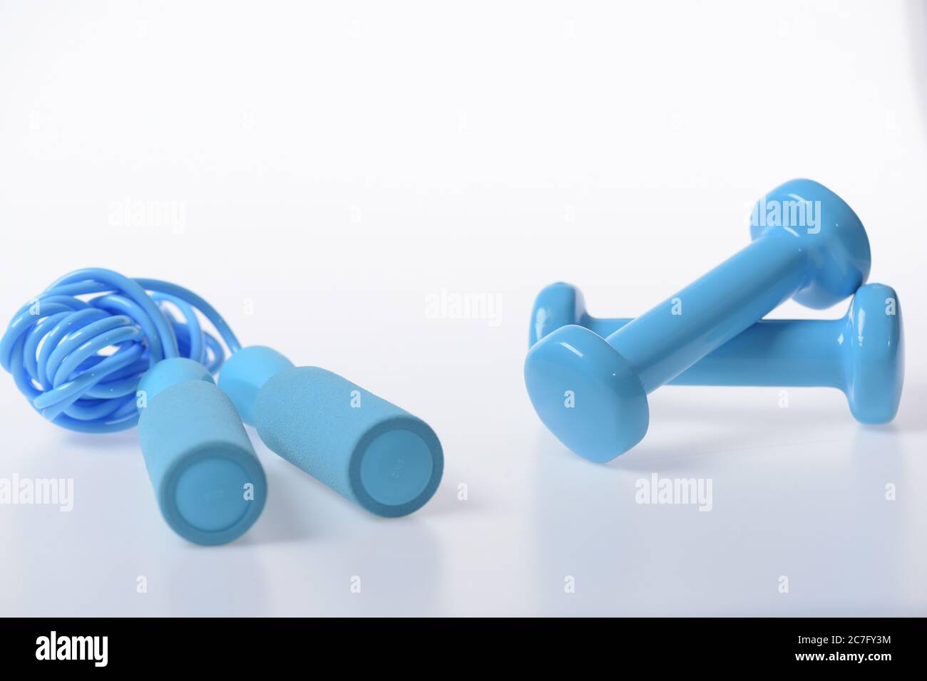 Health regime and fitness symbols. Jump rope and barbells placed next ...