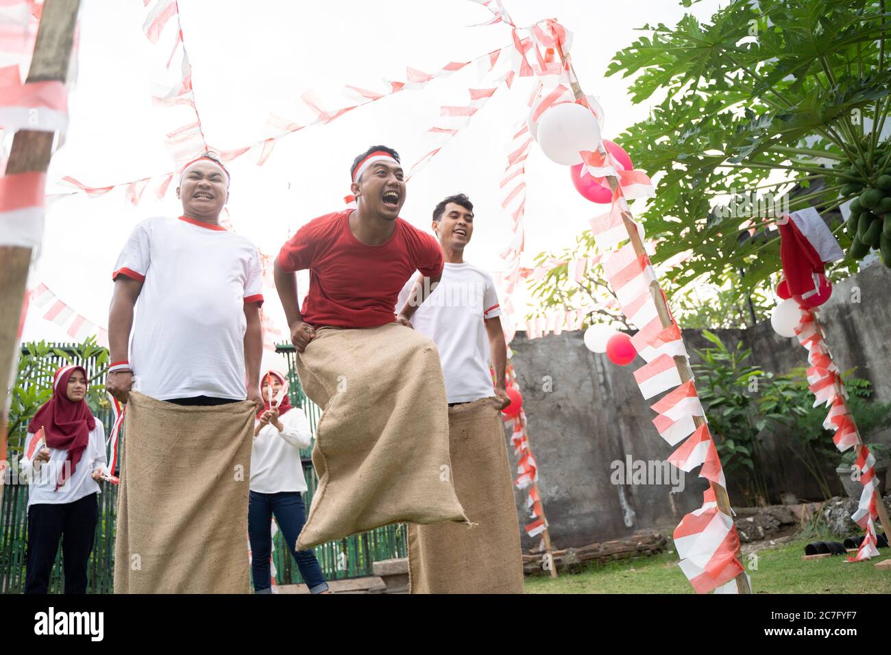 Sack race participants jumped each other by jumping to quickly reach ...