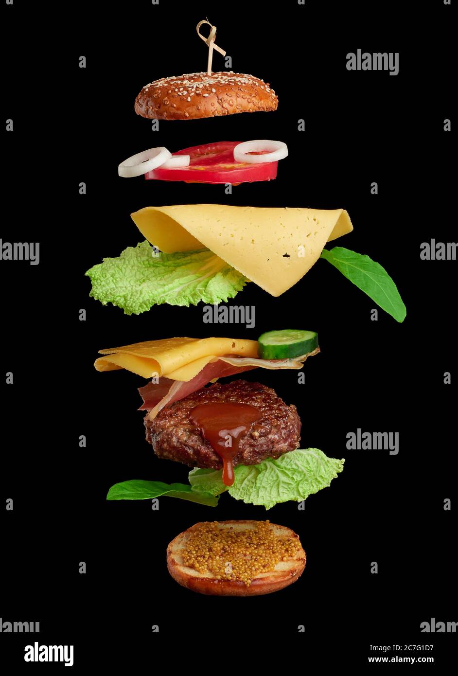levitating cheeseburger ingredients: juicy meat cutlet, cheddar cheese ...