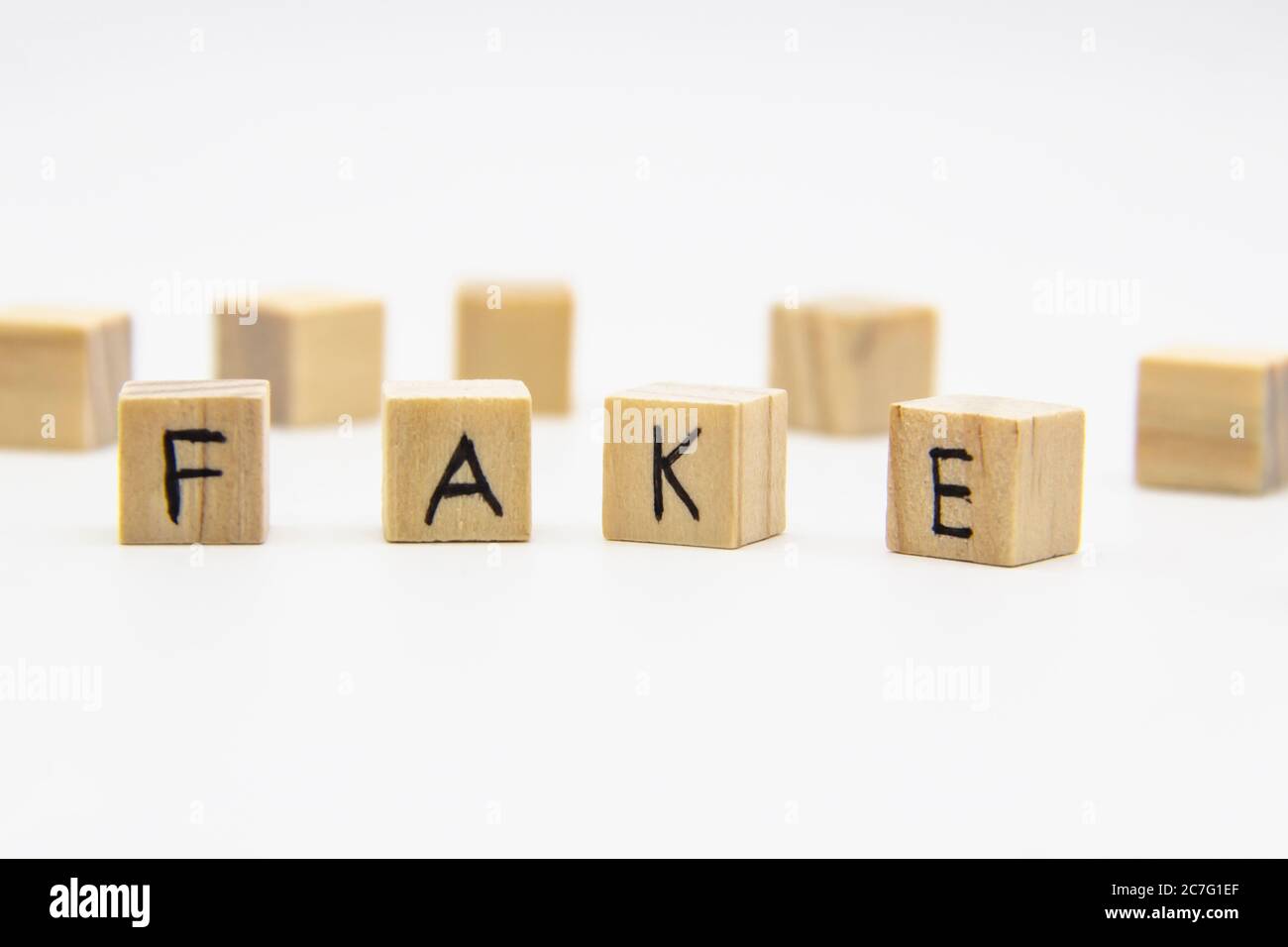 A word fake written on the wood cubes. Fake lettering made of wooden ...