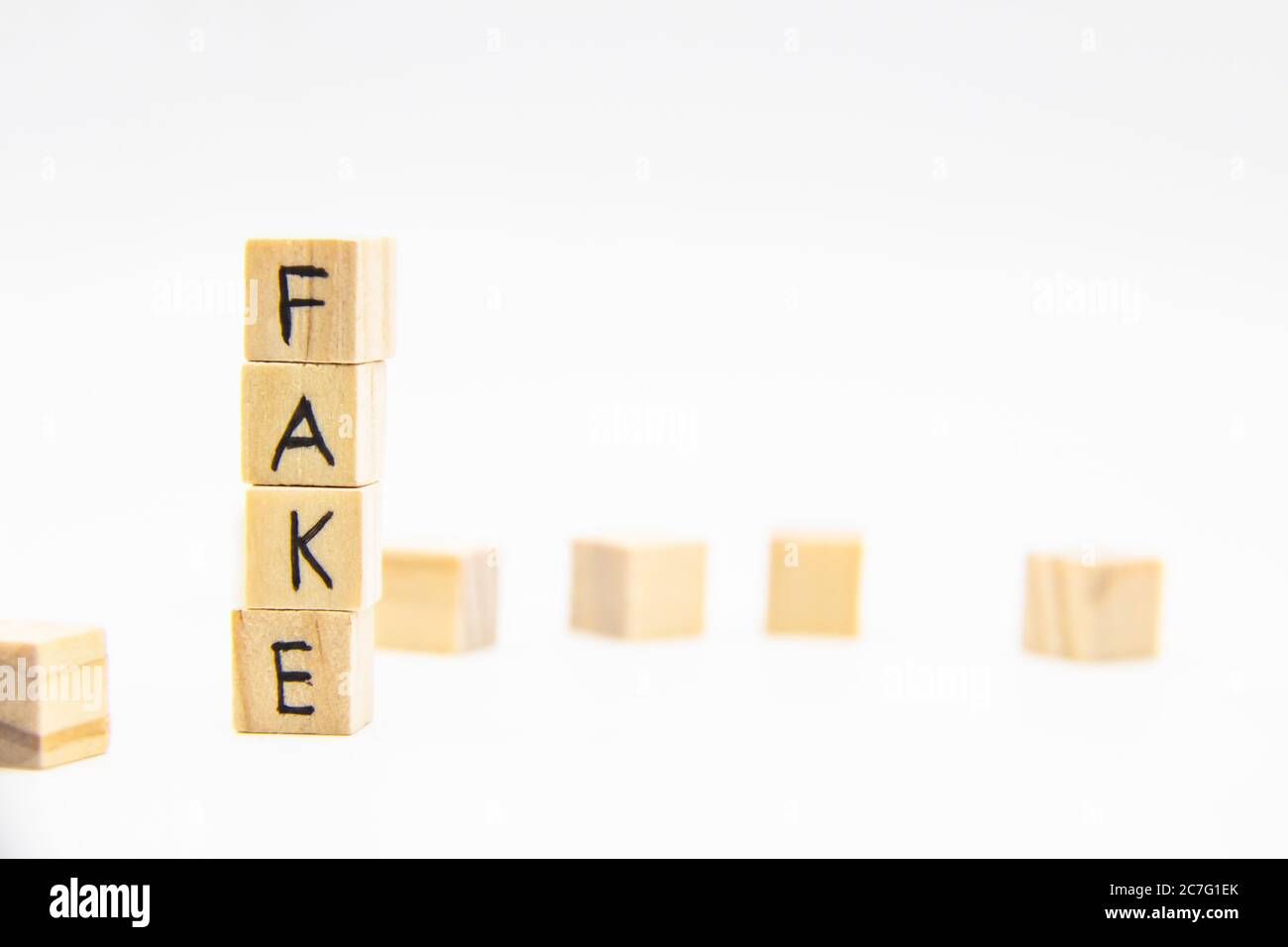 A word fake written on the wood cubes. Fake lettering made of wooden ...