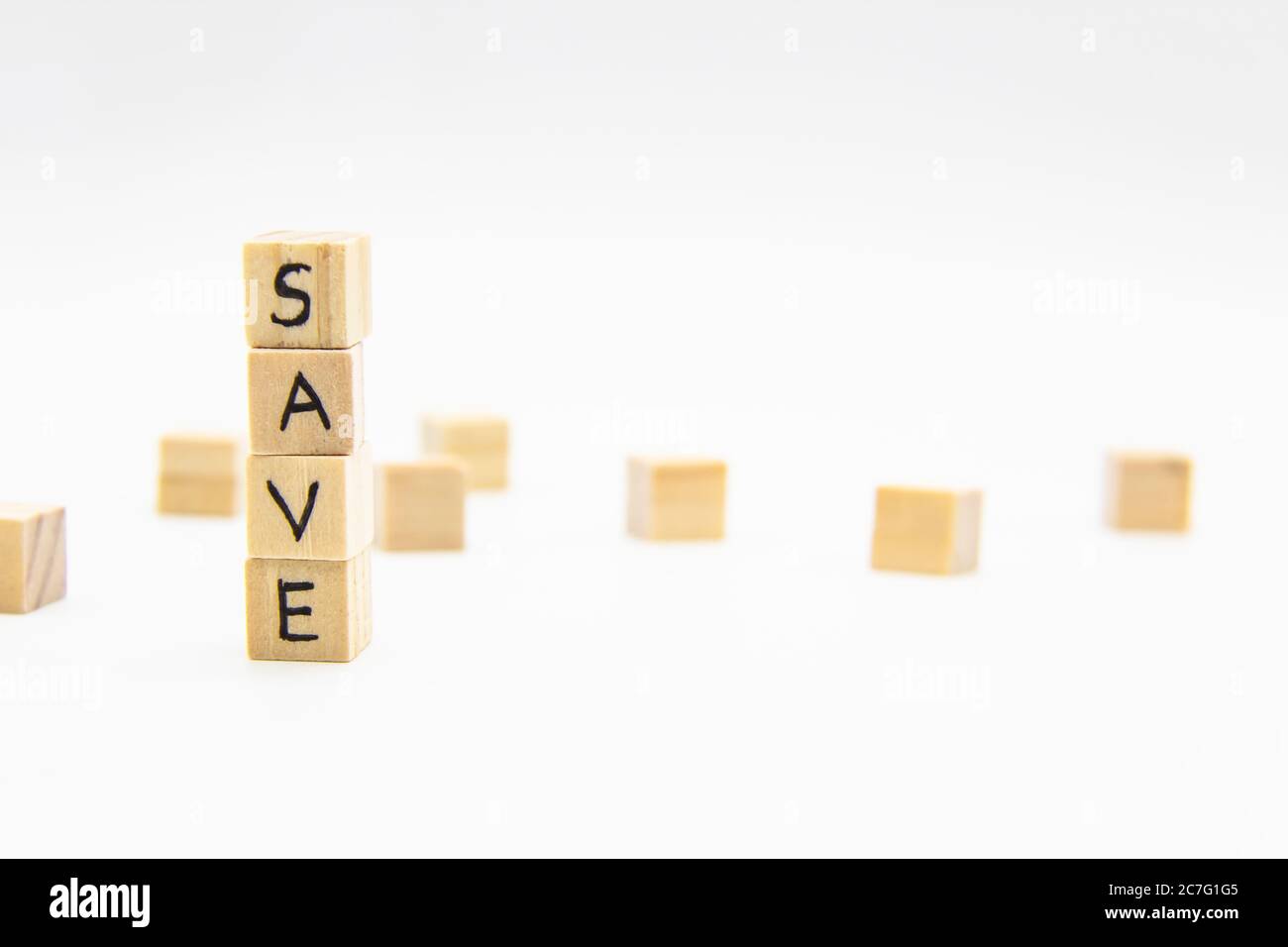 A word Save written on the wood cubes. Save lettering made of wooden ...