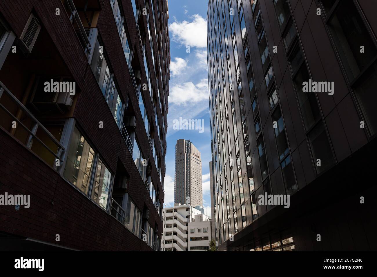 Cerulean Tower seen down a narrow street with tall buildings on either ...