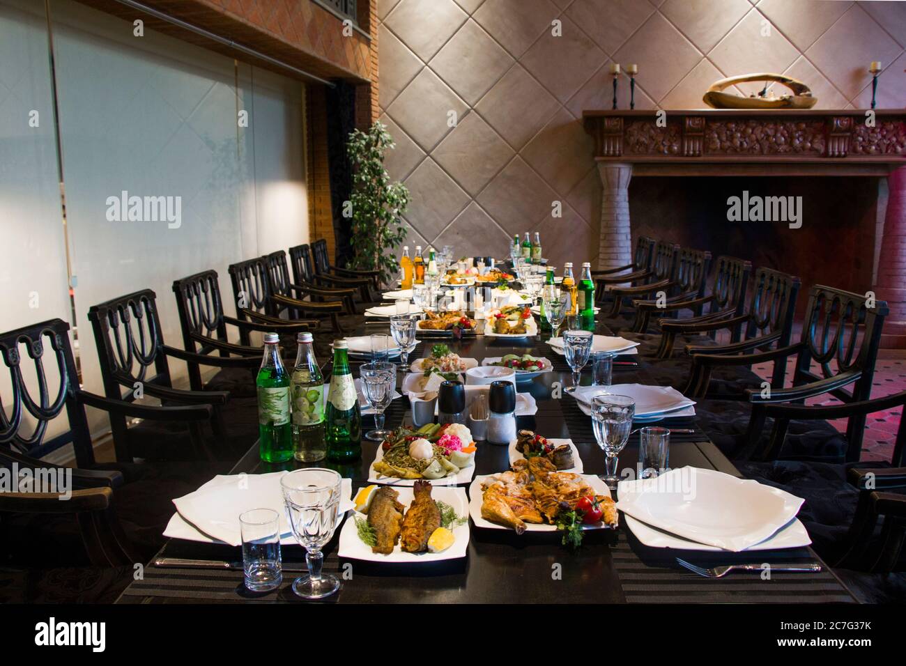 Full table with food and drink in restaurant, bar and cafe. Vegetables ...