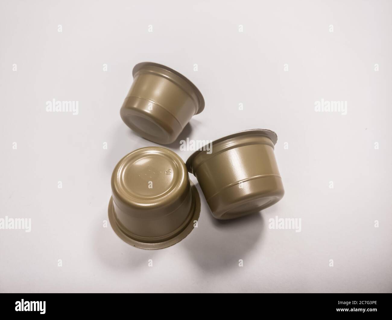 White background with brown coffee machine capsules Stock Photo - Alamy