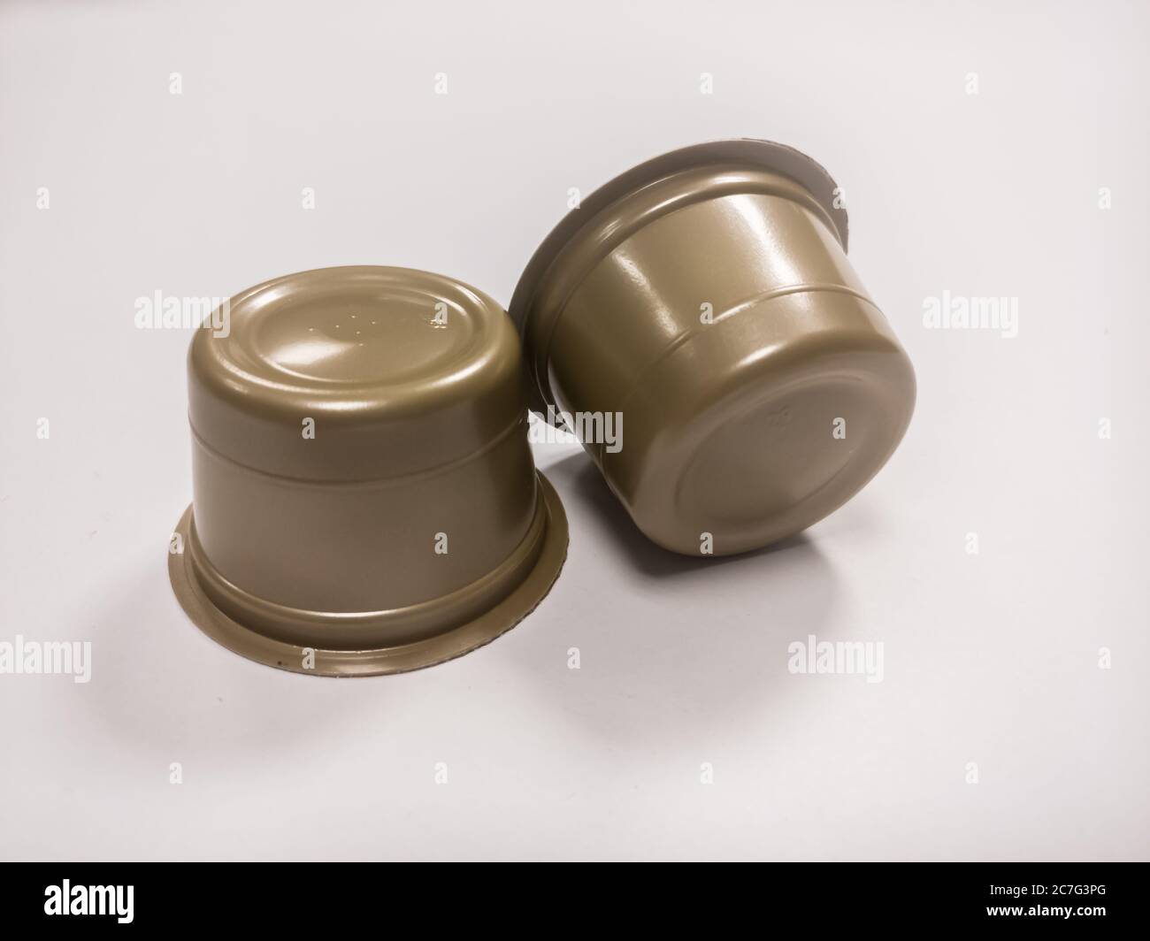 White background with brown coffee machine capsules Stock Photo - Alamy