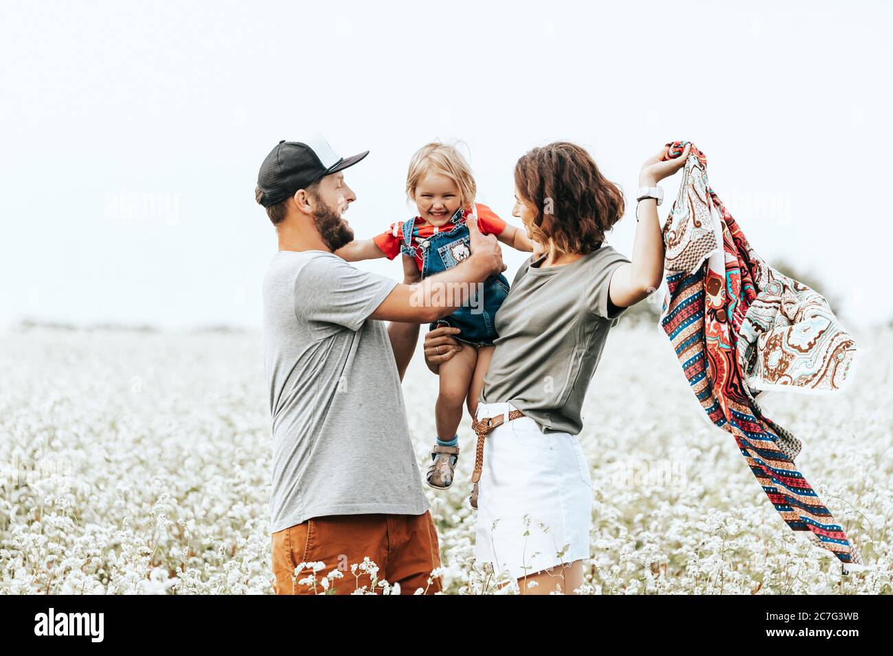 Happy family enjoying life together in an open-air meadow. Outdoor ...