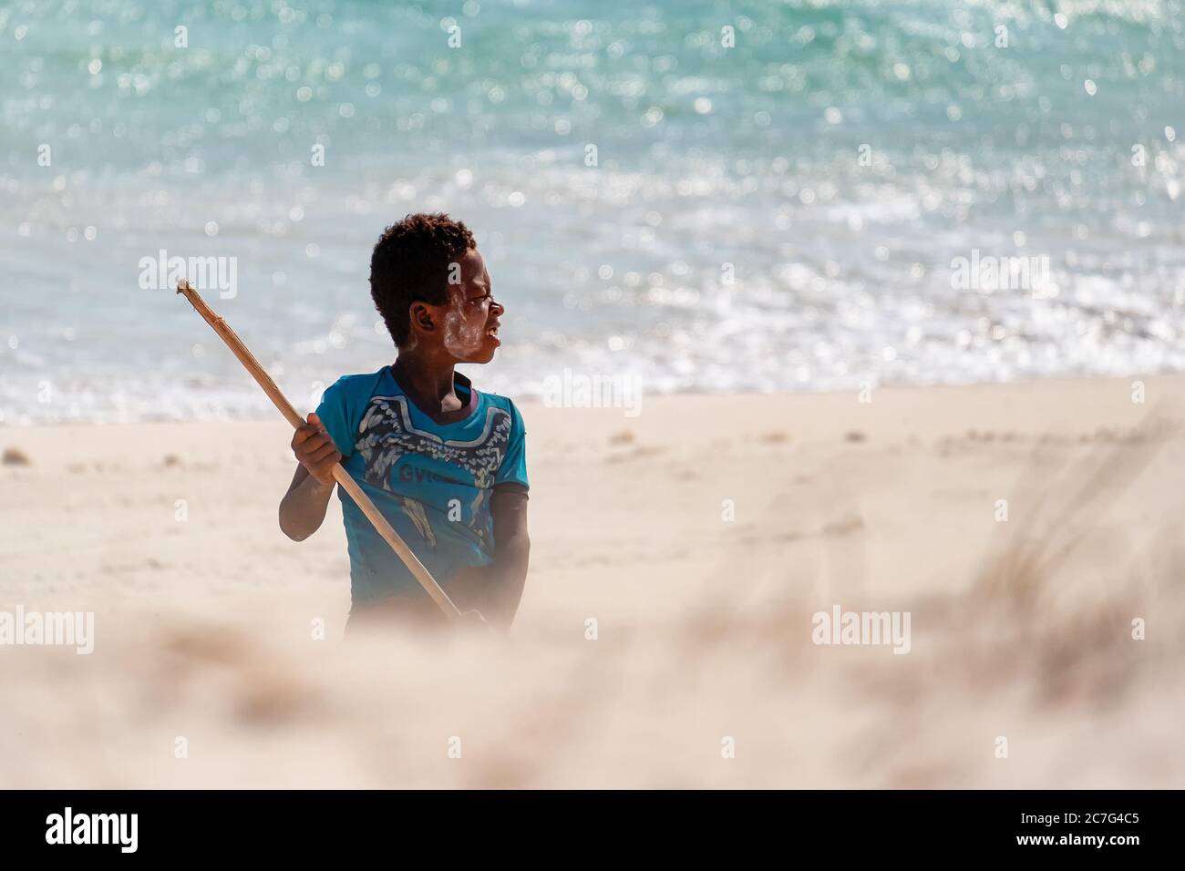 AMBATOMILO, MADAGASCAR - Aug 15, 2019: A kid playing alone on the beach ...
