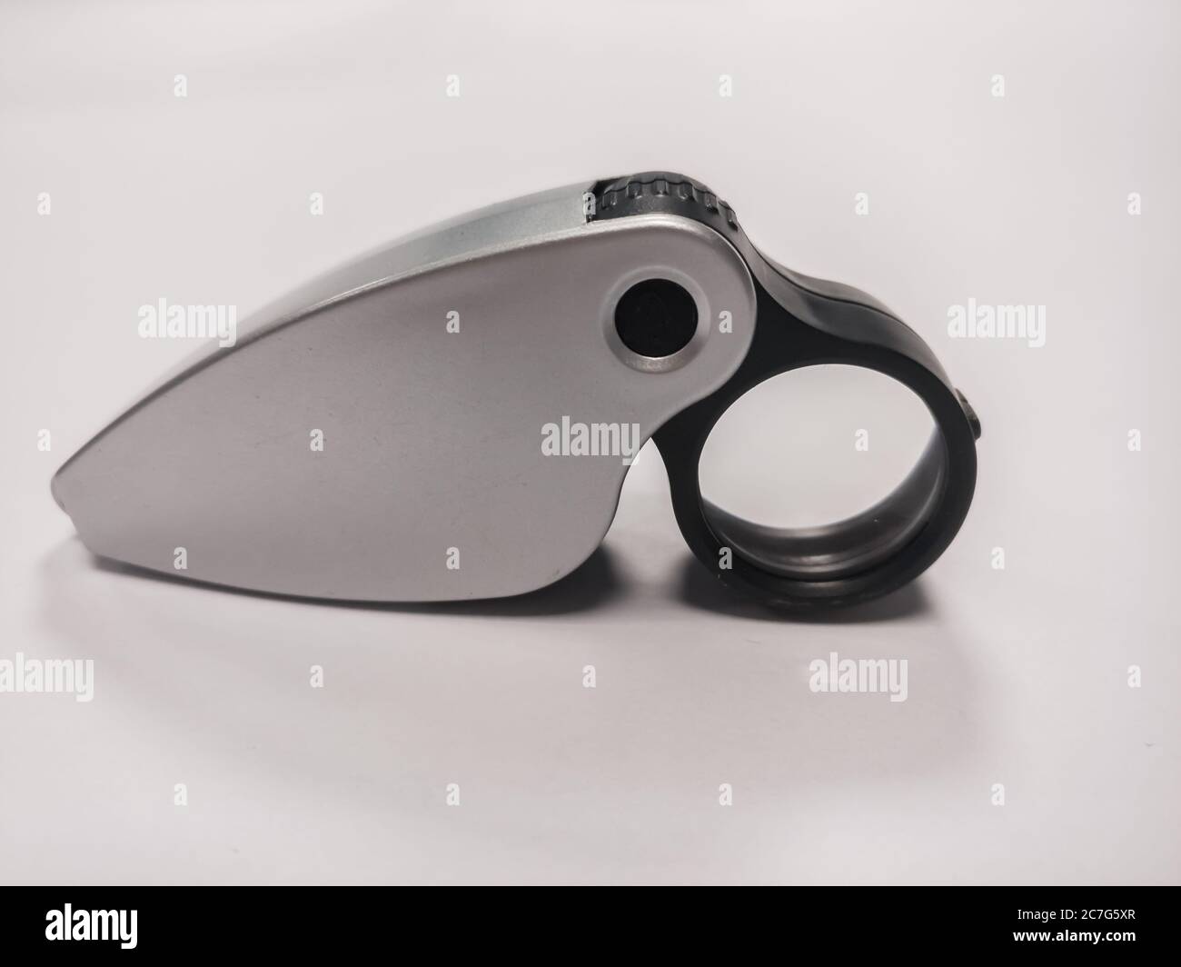 Folding metal magnifying glass on a white background Stock Photo - Alamy