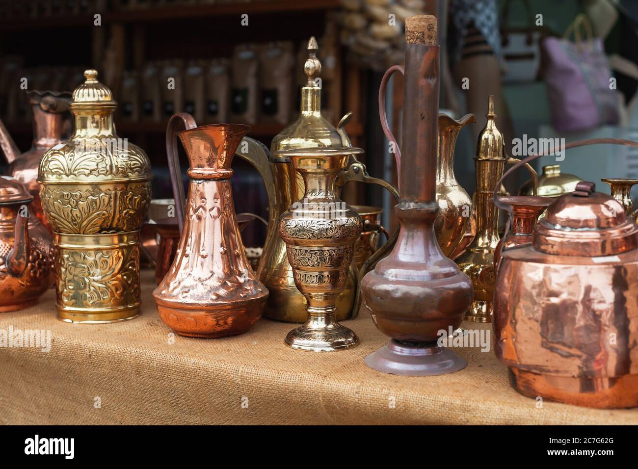Assortment of an Oriental copper dishware standing on a counter of gift ...