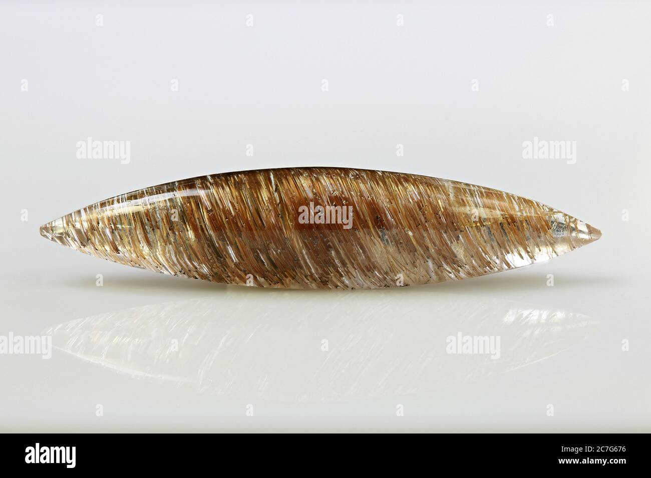 Quartz cut gem with rutile inclusions Stock Photo - Alamy