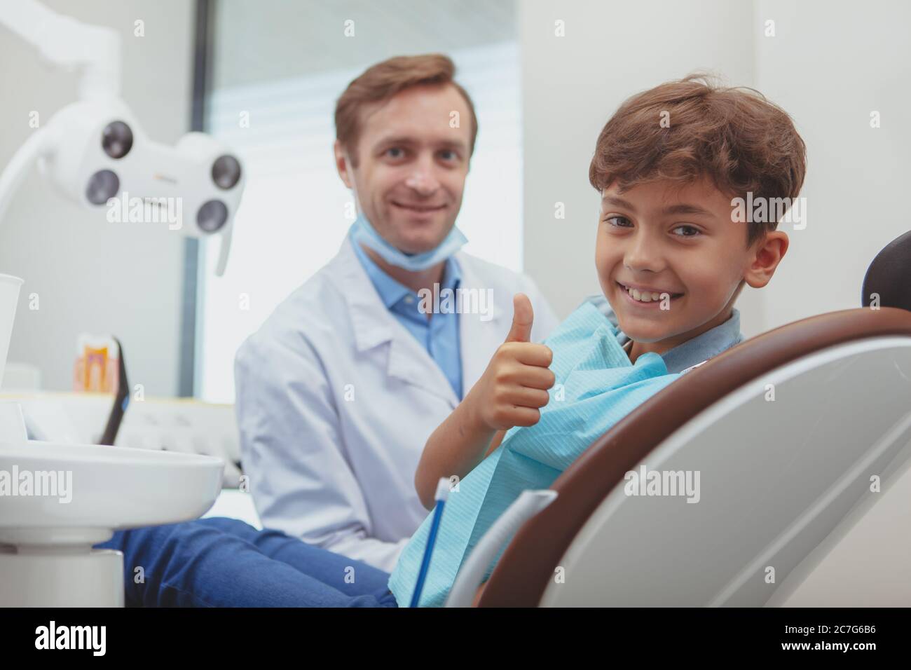 Happy healthy kids concept. Charming young boy smiling, showing thumbs ...