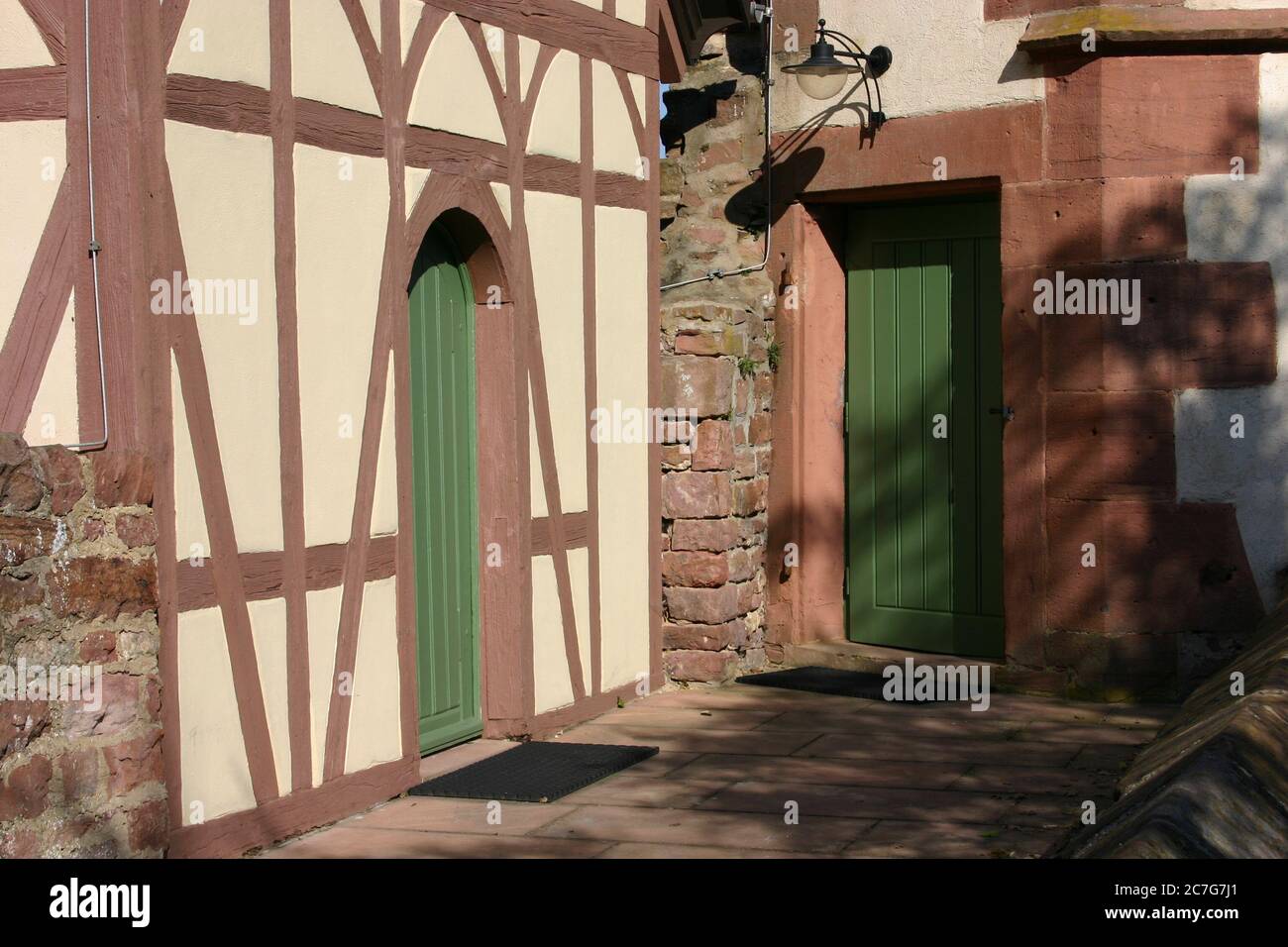 Half-timbered house and sandstone arches on an old building in southern ...