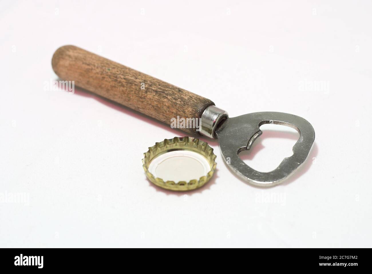 cap lifter with wooden handle on white surface Stock Photo - Alamy