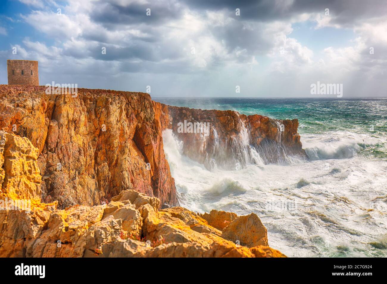 Fantastic view of cliffs in valley Cala Domestica with old tower and ...