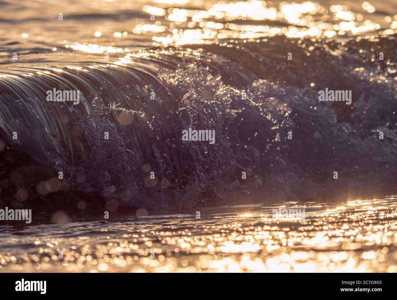 wave splash sea beach close up macro sunrise Stock Photo - Alamy
