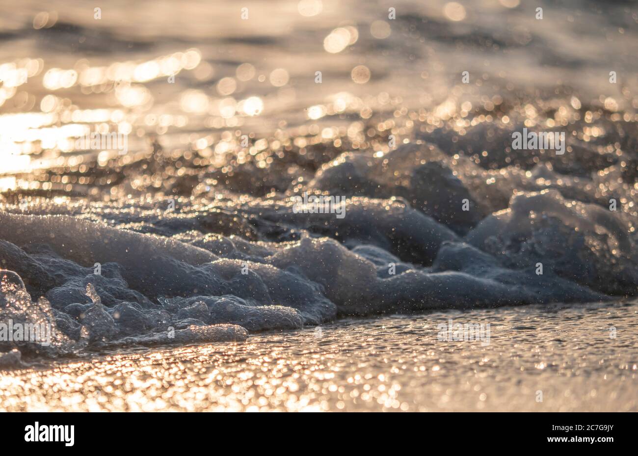 wave splash sea beach close up macro sunrise Stock Photo - Alamy
