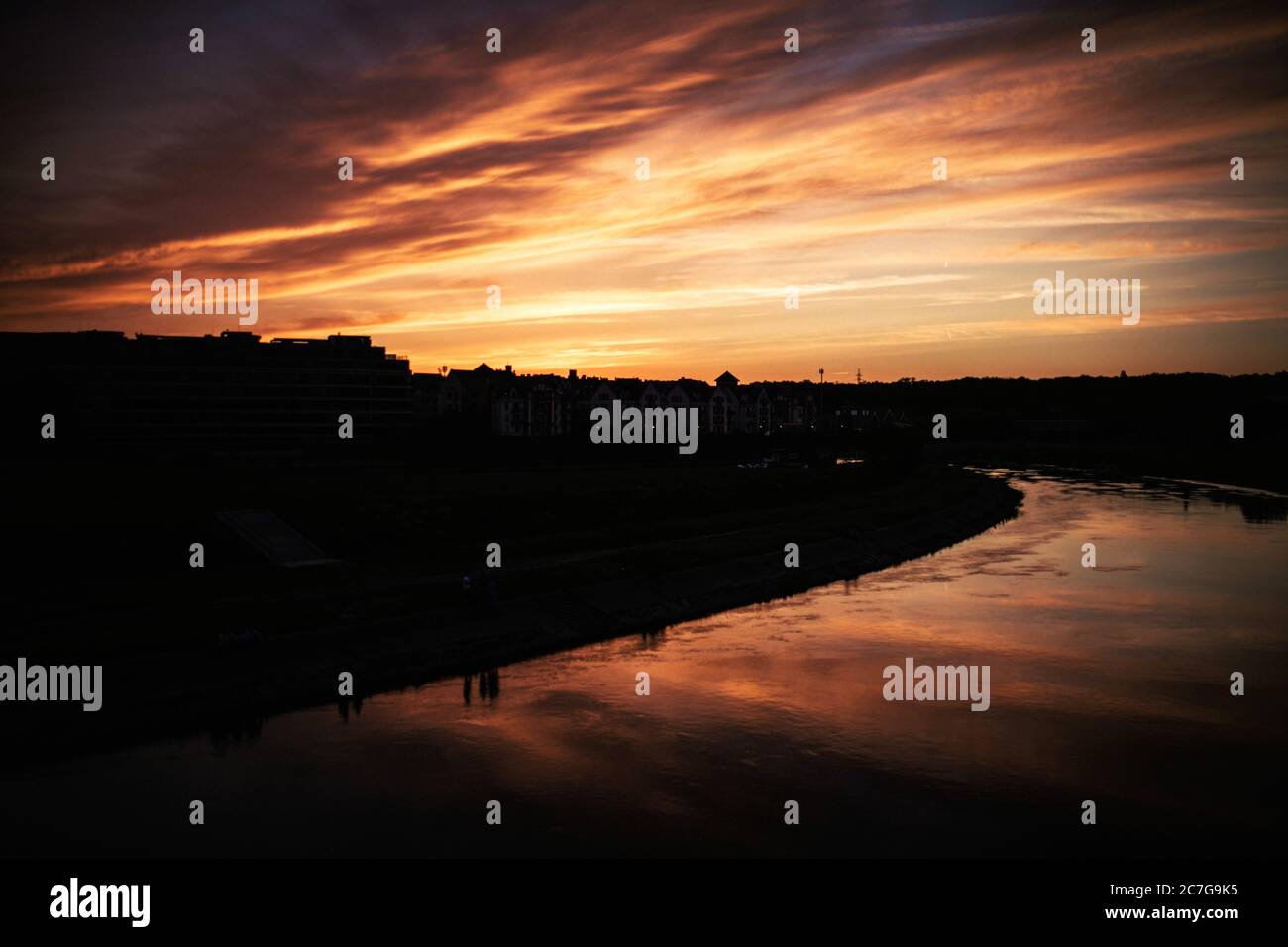 Beautiful view of the buildings by the river under the breathtaking sky ...