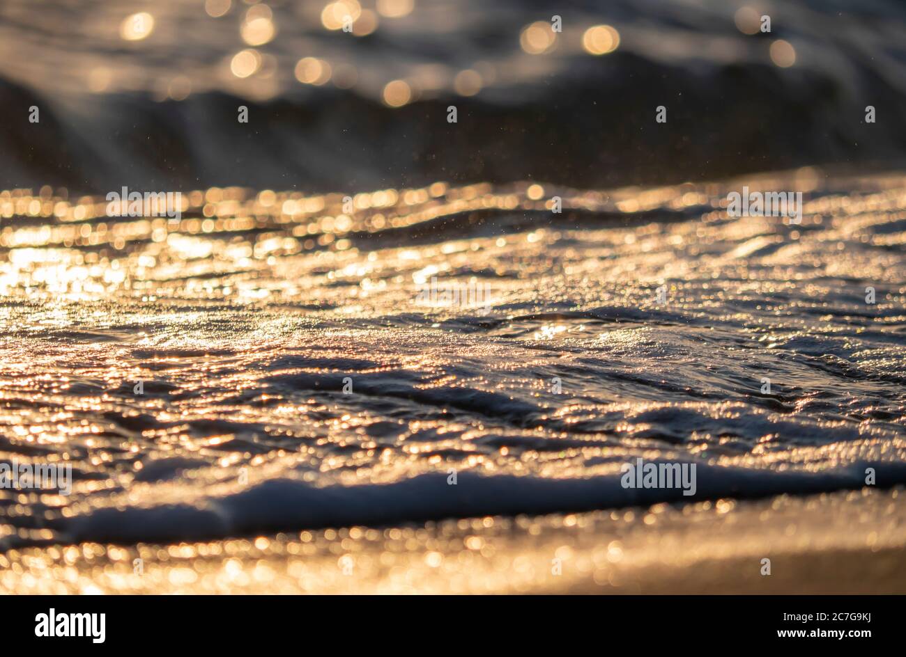 wave splash sea beach close up macro sunrise Stock Photo - Alamy