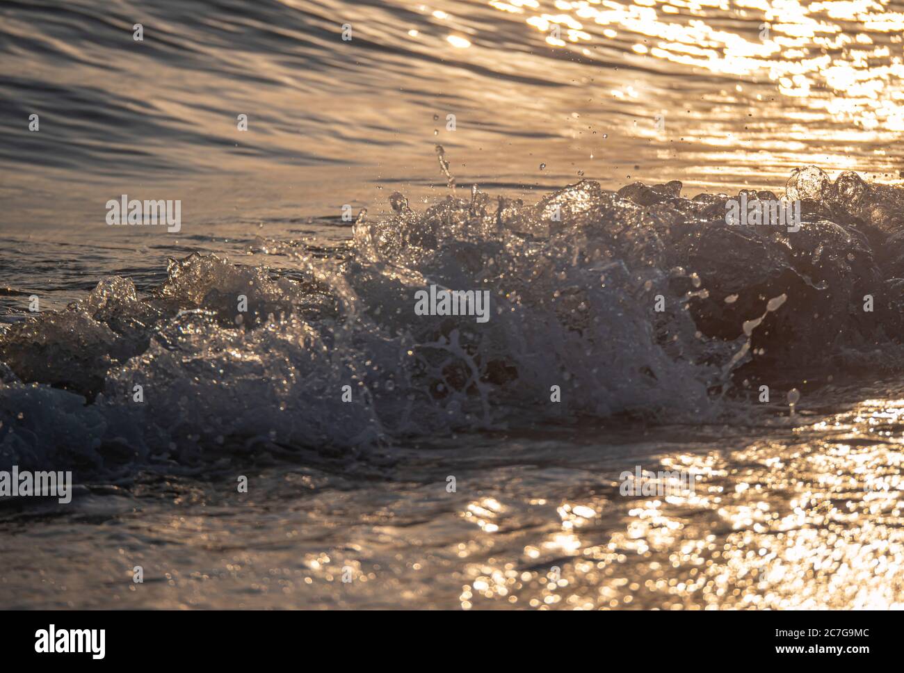 wave splash sea beach close up macro sunrise Stock Photo - Alamy