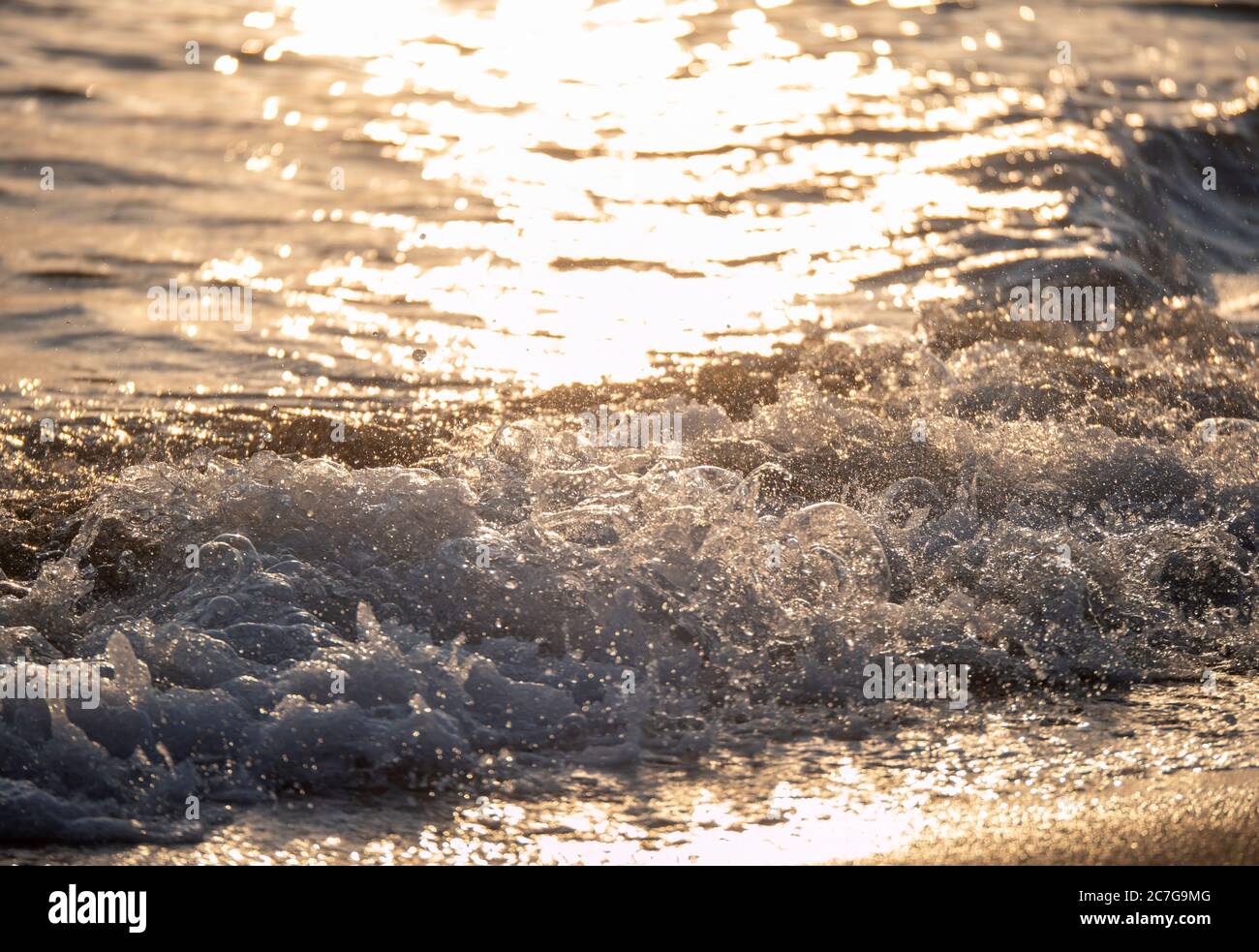 wave splash sea beach close up macro sunrise Stock Photo - Alamy