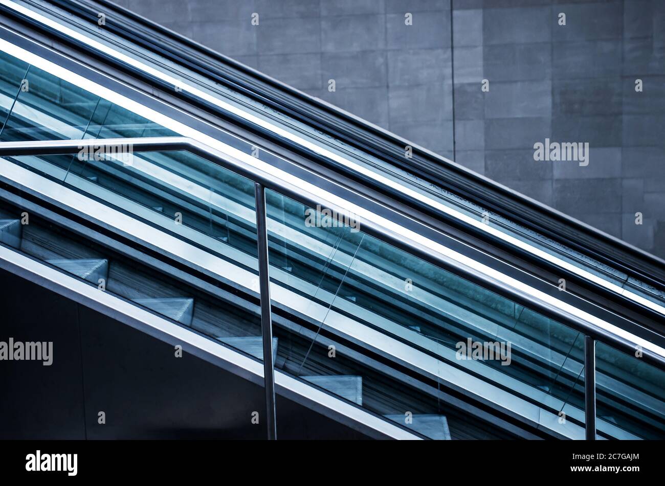 Escalators in a building with grey walls Stock Photo - Alamy