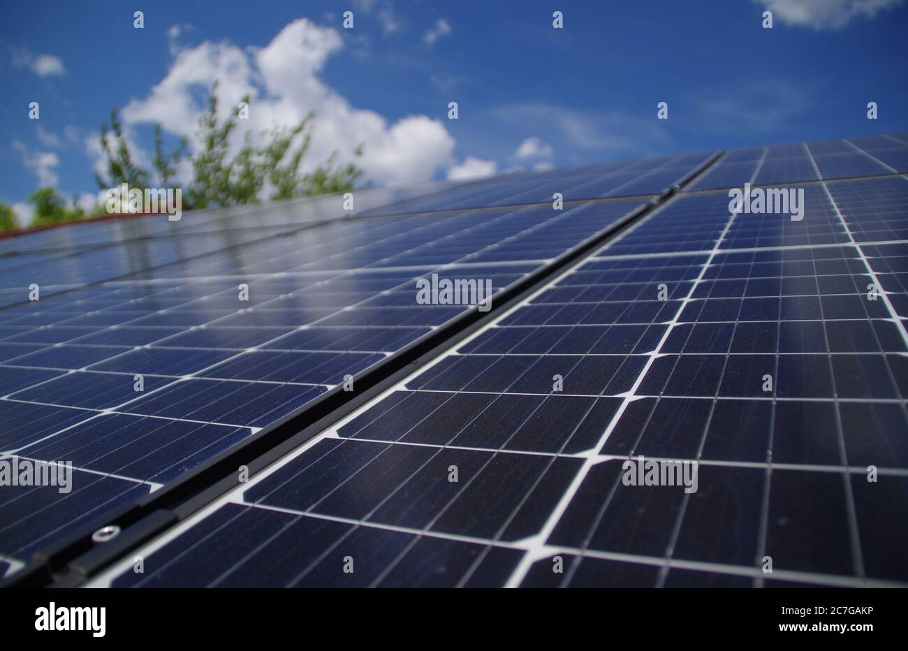 Photovoltaic energy station at home with sky clouds reflection. Solar ...