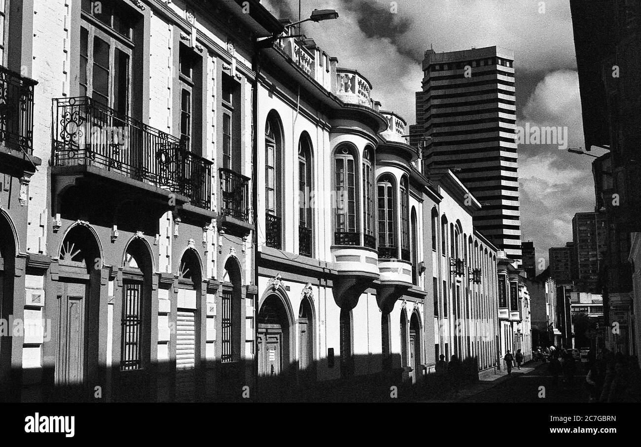 Grey scale shot of beautiful buildings on a paved street under the ...