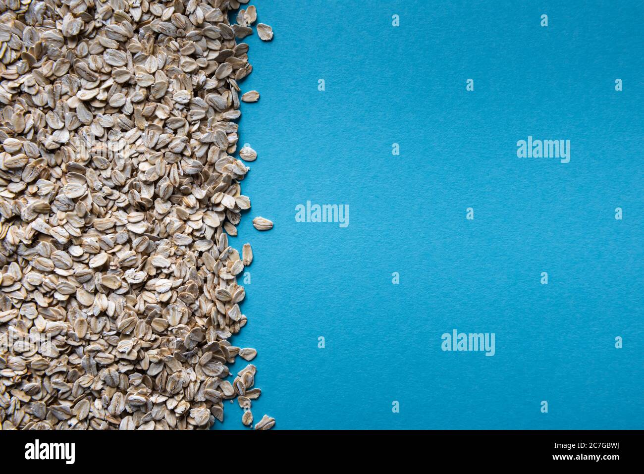 Background with natural dry rolled oats and with large square copy ...
