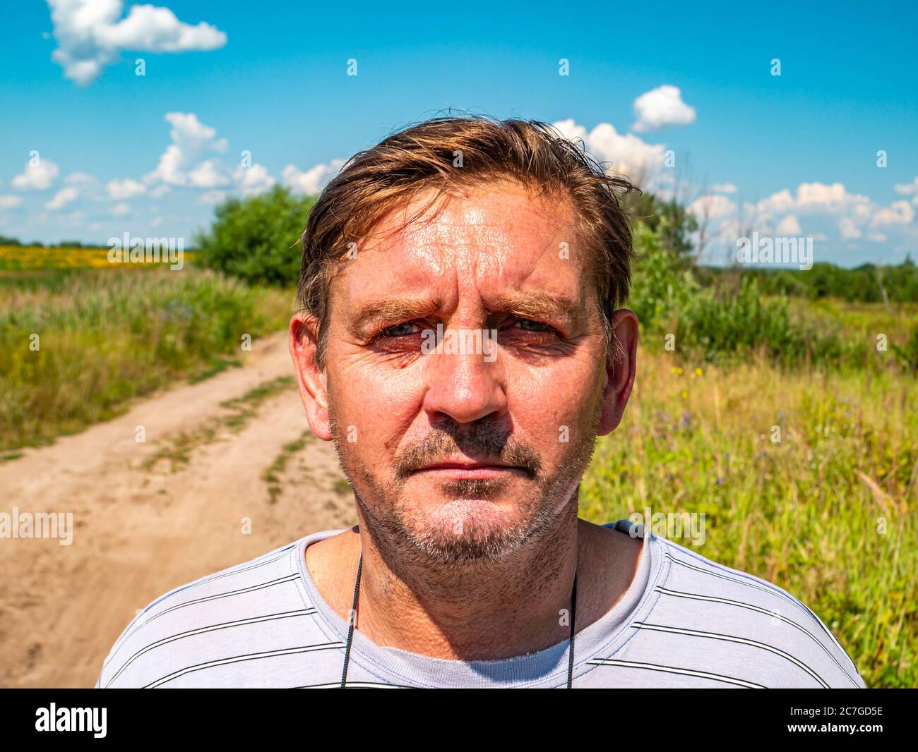 Man against blue sky background with clouds Stock Photo - Alamy