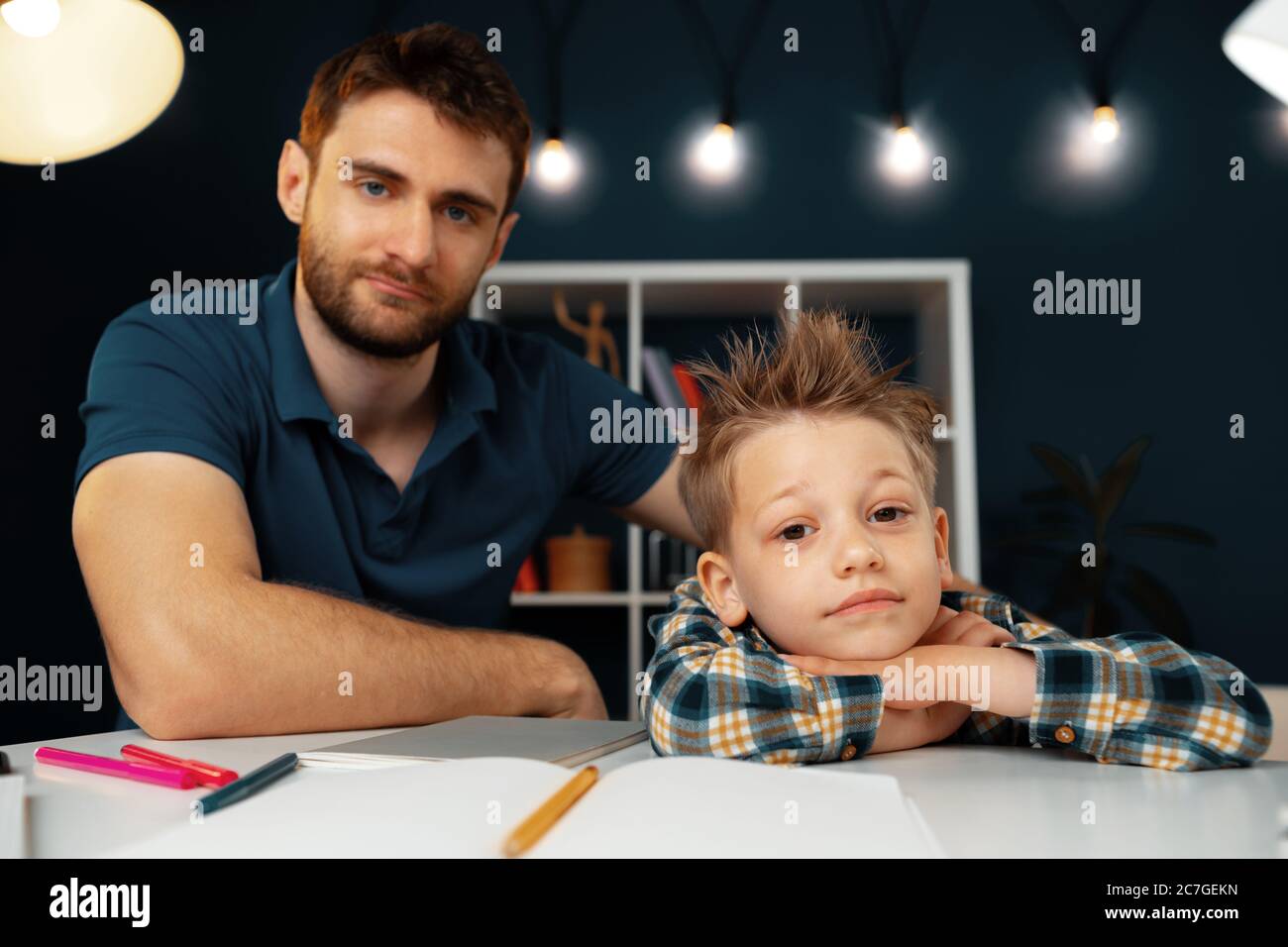 Dad and son doing school homework together Stock Photo - Alamy