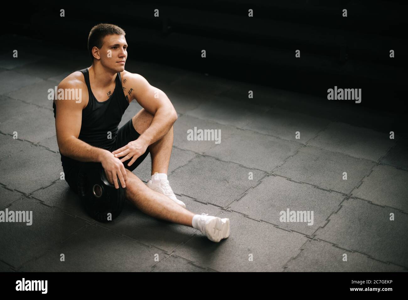Muscular man sitting on floor hi-res stock photography and images - Alamy