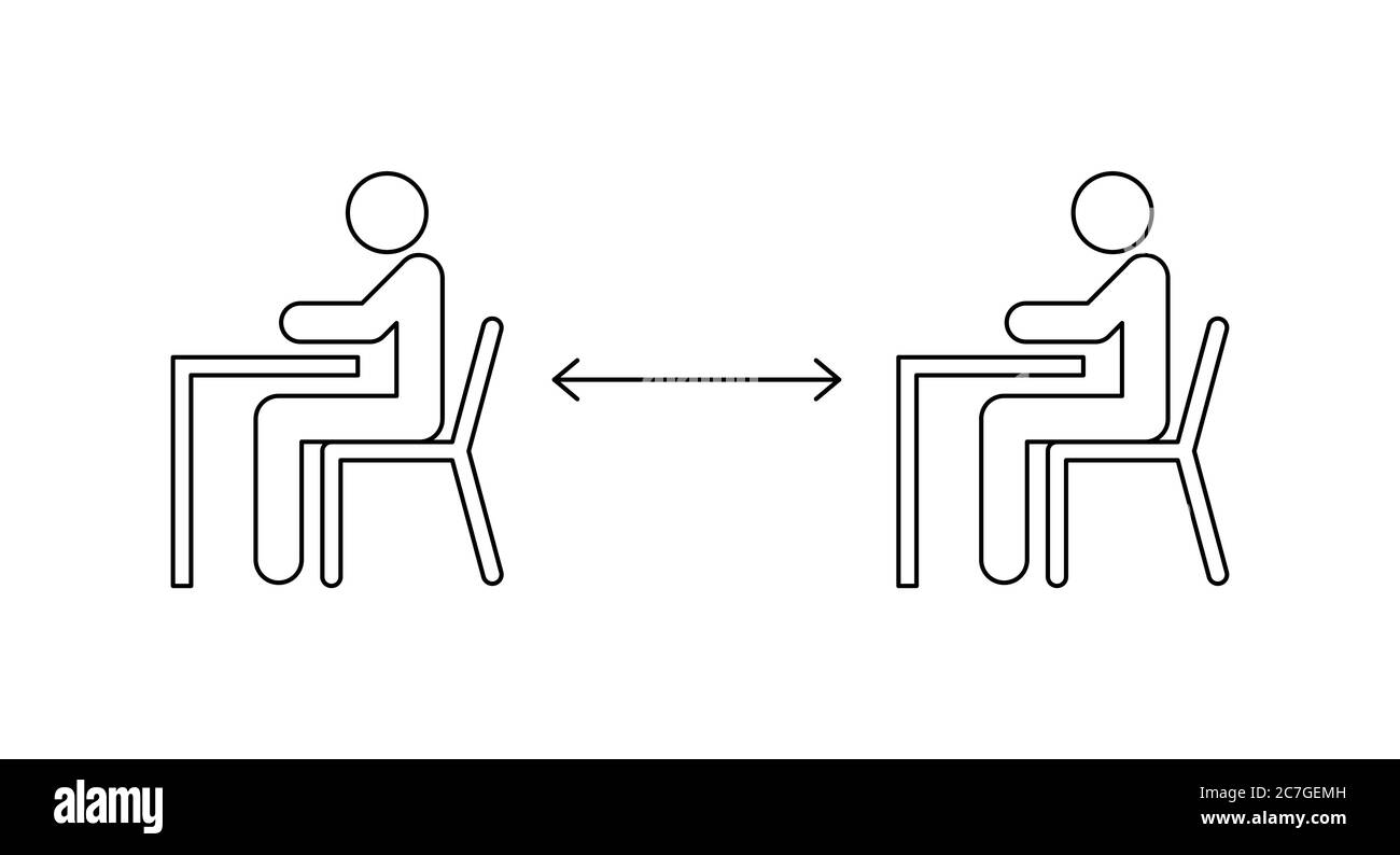 Keep safe distance at school concept. Two students sitting at tables ...