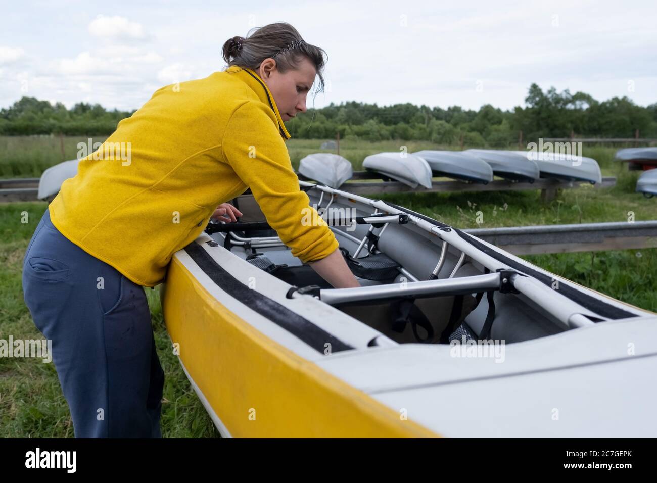 Caucasian woman washing kayak after swimming in the river Stock Photo ...