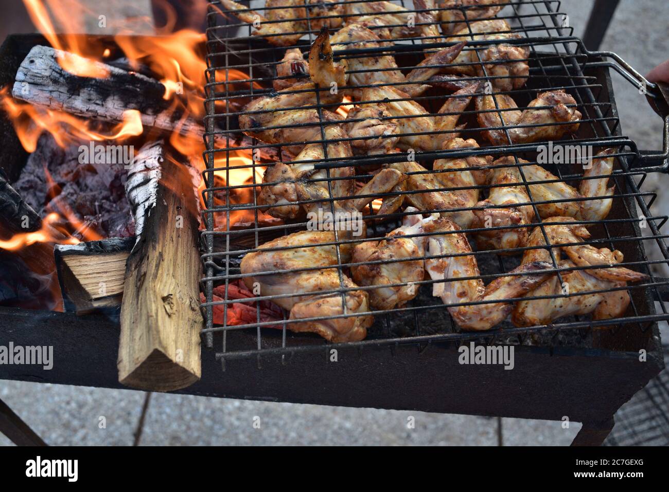 The process of cooking outdoors. Cooking at the stake. Chicken wings ...
