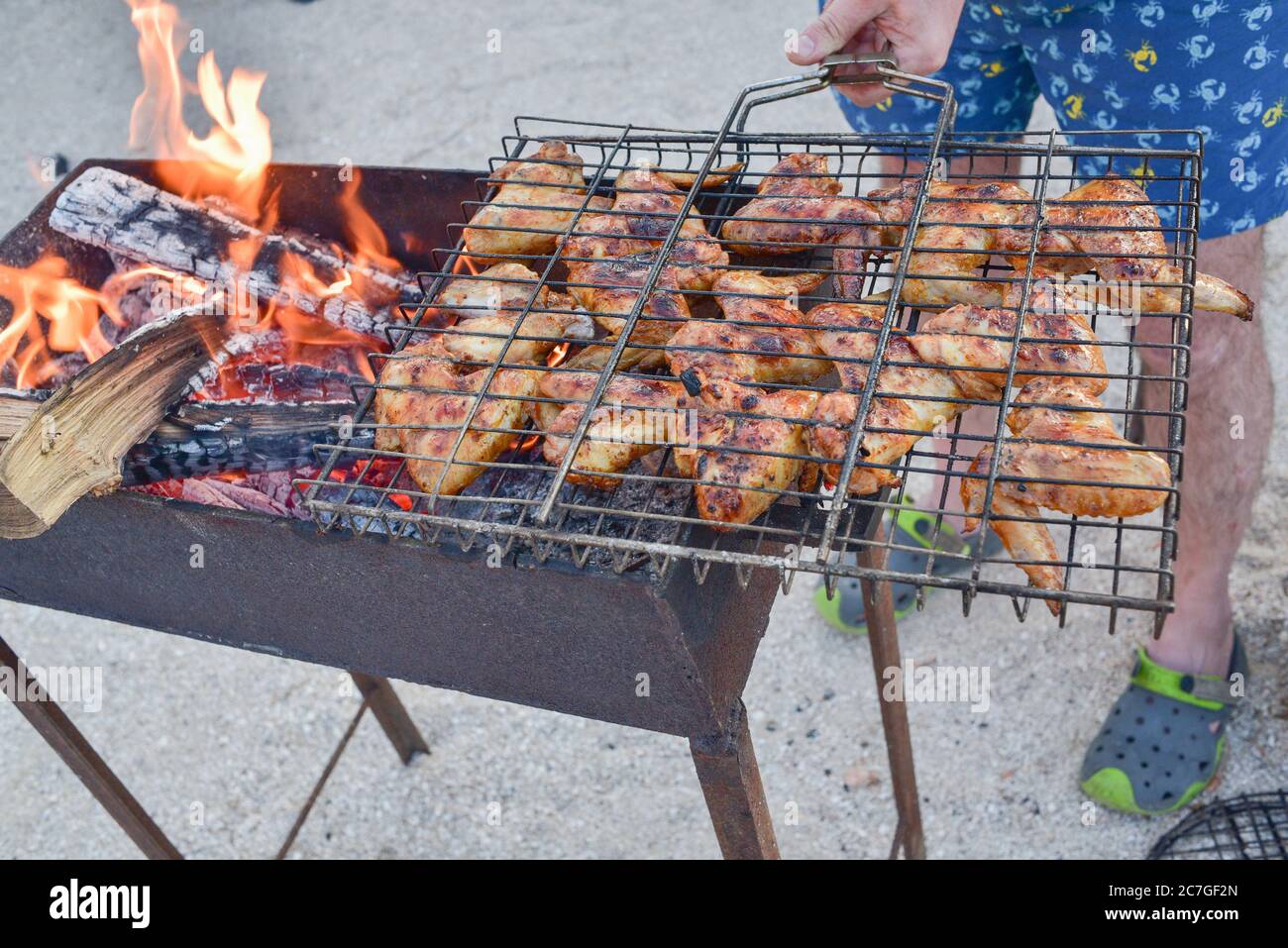 The process of cooking outdoors. Cooking at the stake. Chicken wings ...