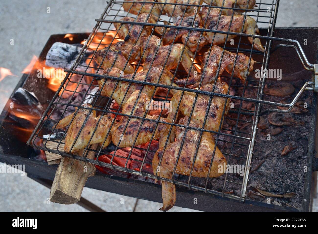 The process of cooking outdoors. Cooking at the stake. Chicken wings ...