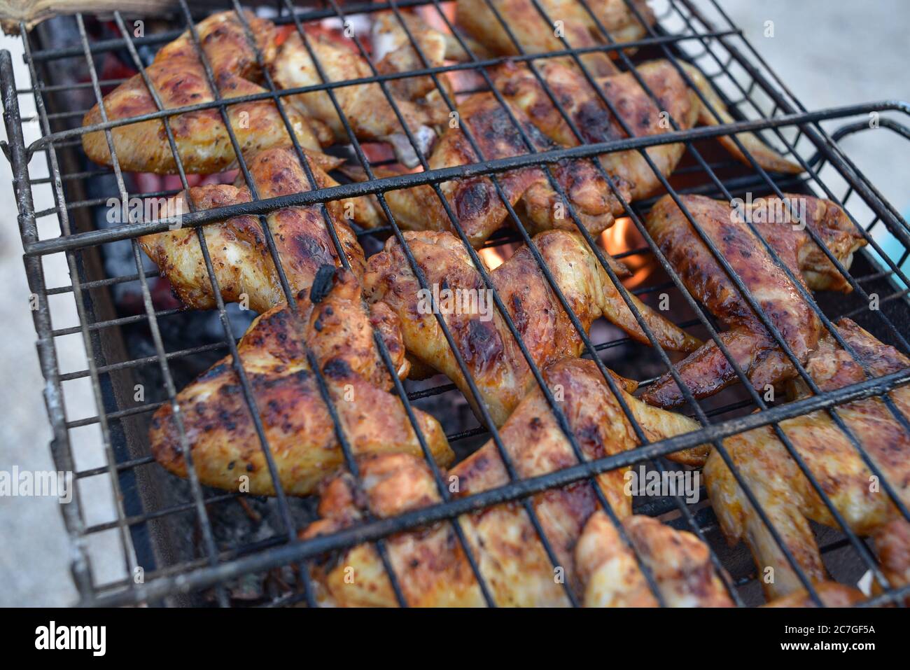 The process of cooking outdoors. Cooking at the stake. Chicken wings ...