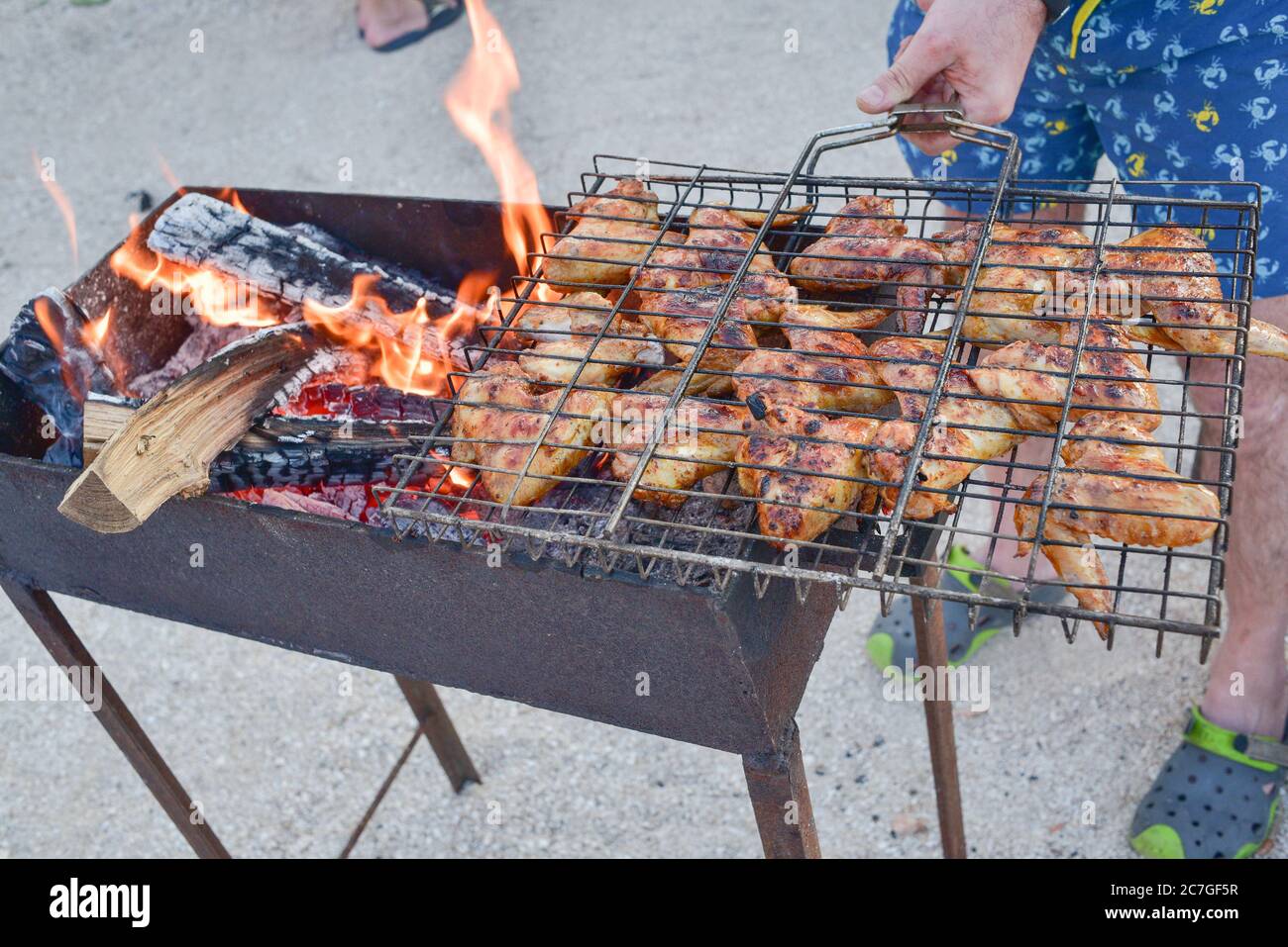 The process of cooking outdoors. Cooking at the stake. Chicken wings ...