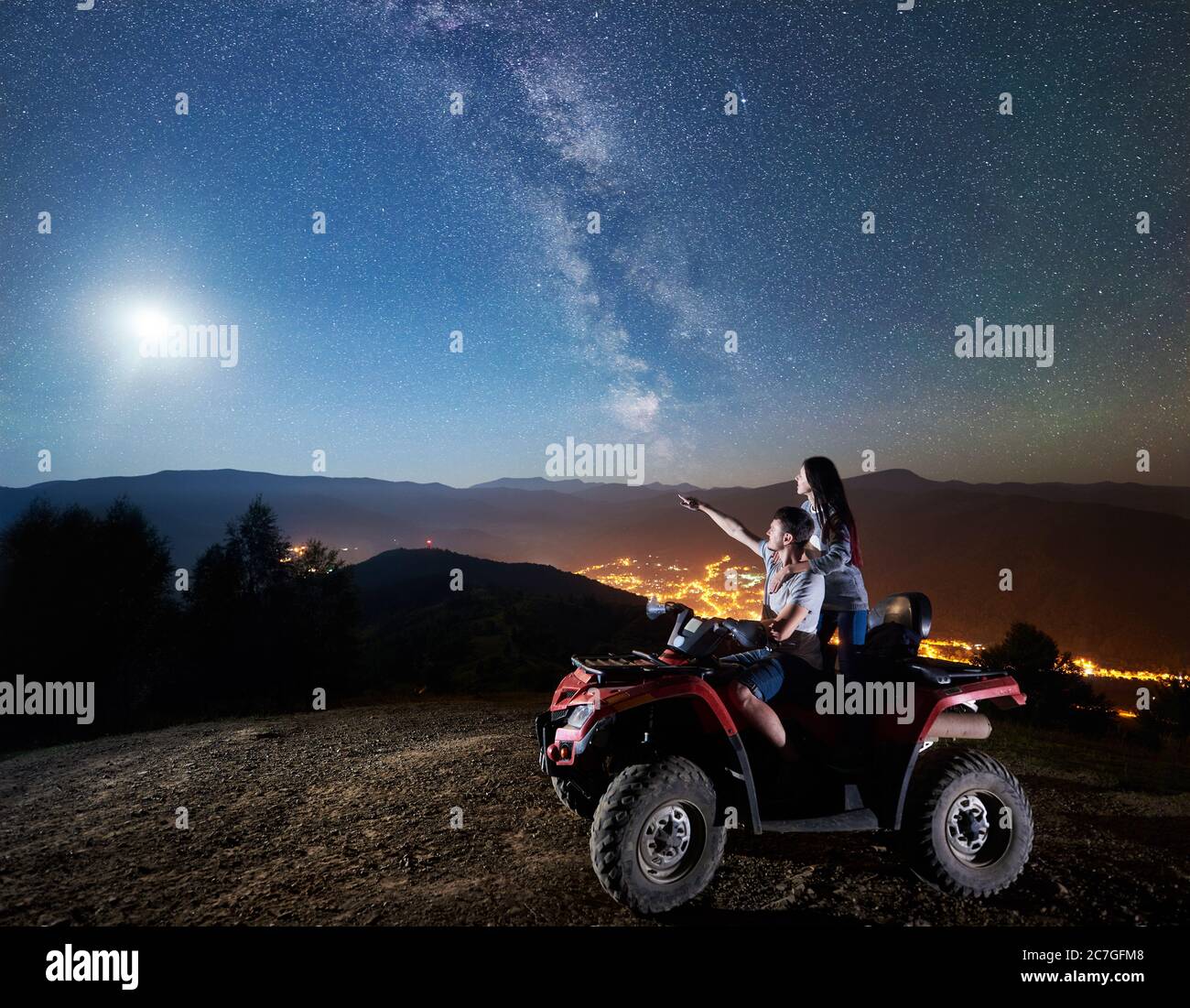 Young couple man and woman tourists riding atv quad motorbike on the ...
