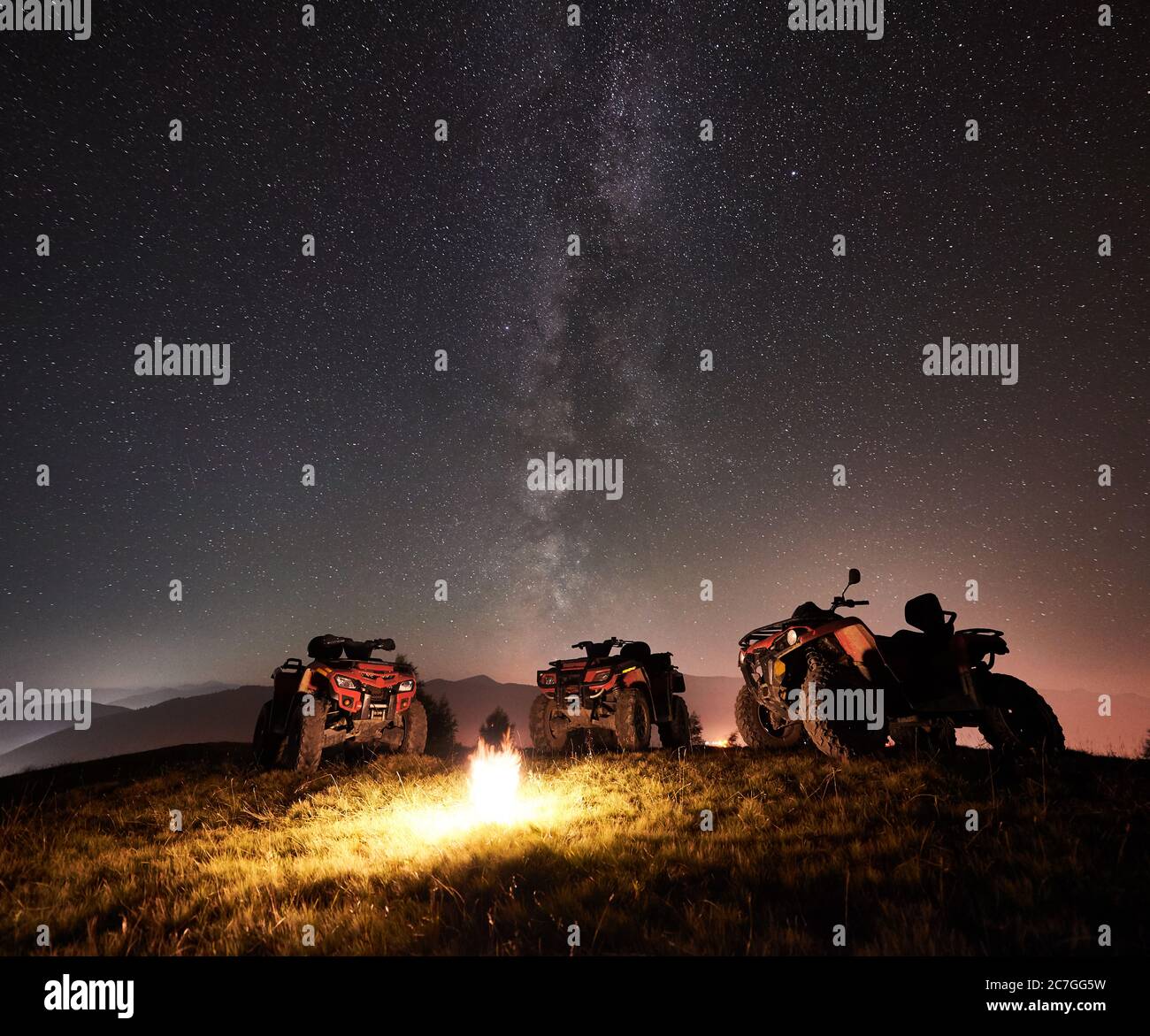 Night picture. Three atv quad motorbikes standing on the top of ...