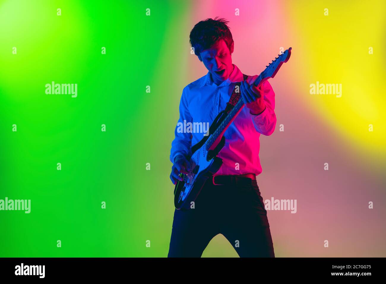 Amazing. Young caucasian inspired and expressive musician, guitarist ...